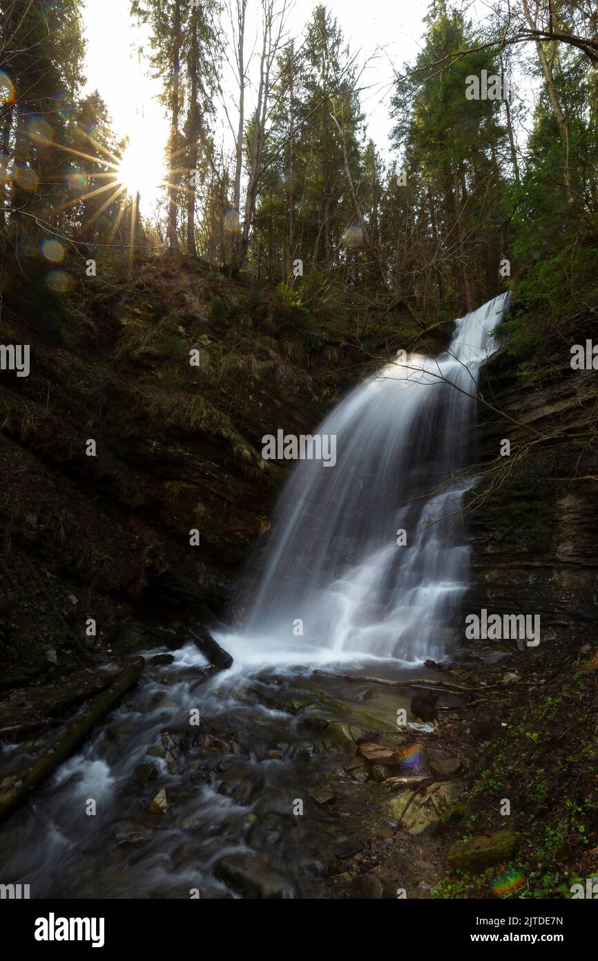 A waterfall in the mountains is an untouched corner of wild nature. A ...