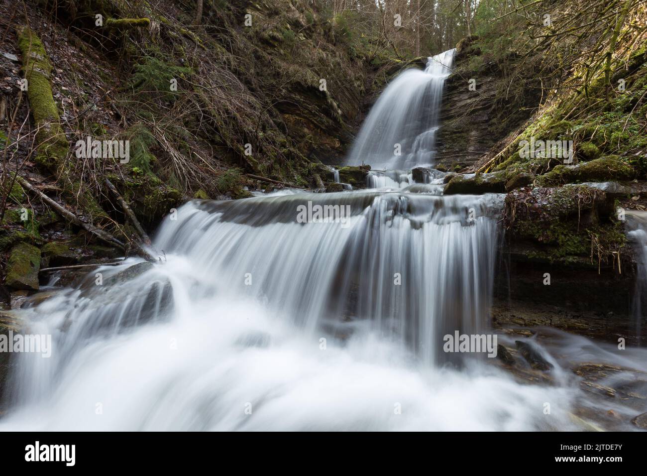A waterfall in the mountains is an untouched corner of wild nature. A ...
