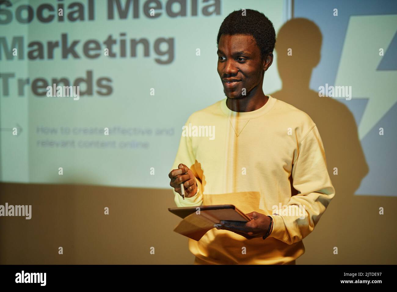 Waist up portrait of young black man giving presentation on marketing ...