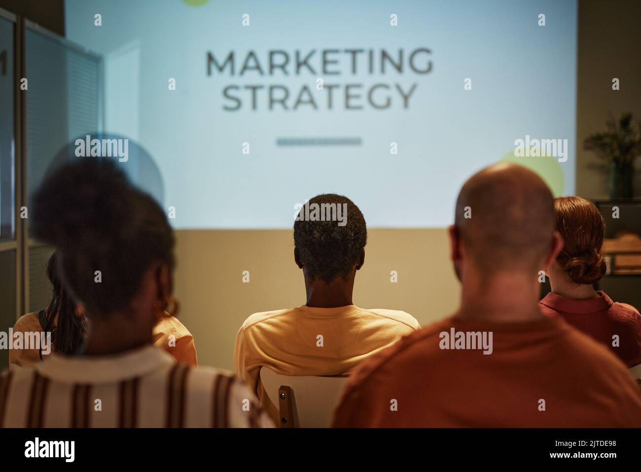 Back view of young black man listening to lecture while sitting in ...