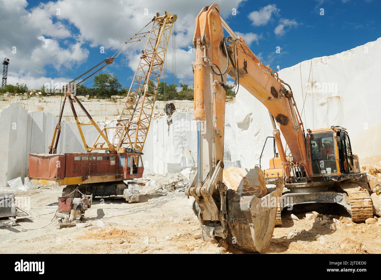 Two caterpillar construction machines working on territory of modern ...