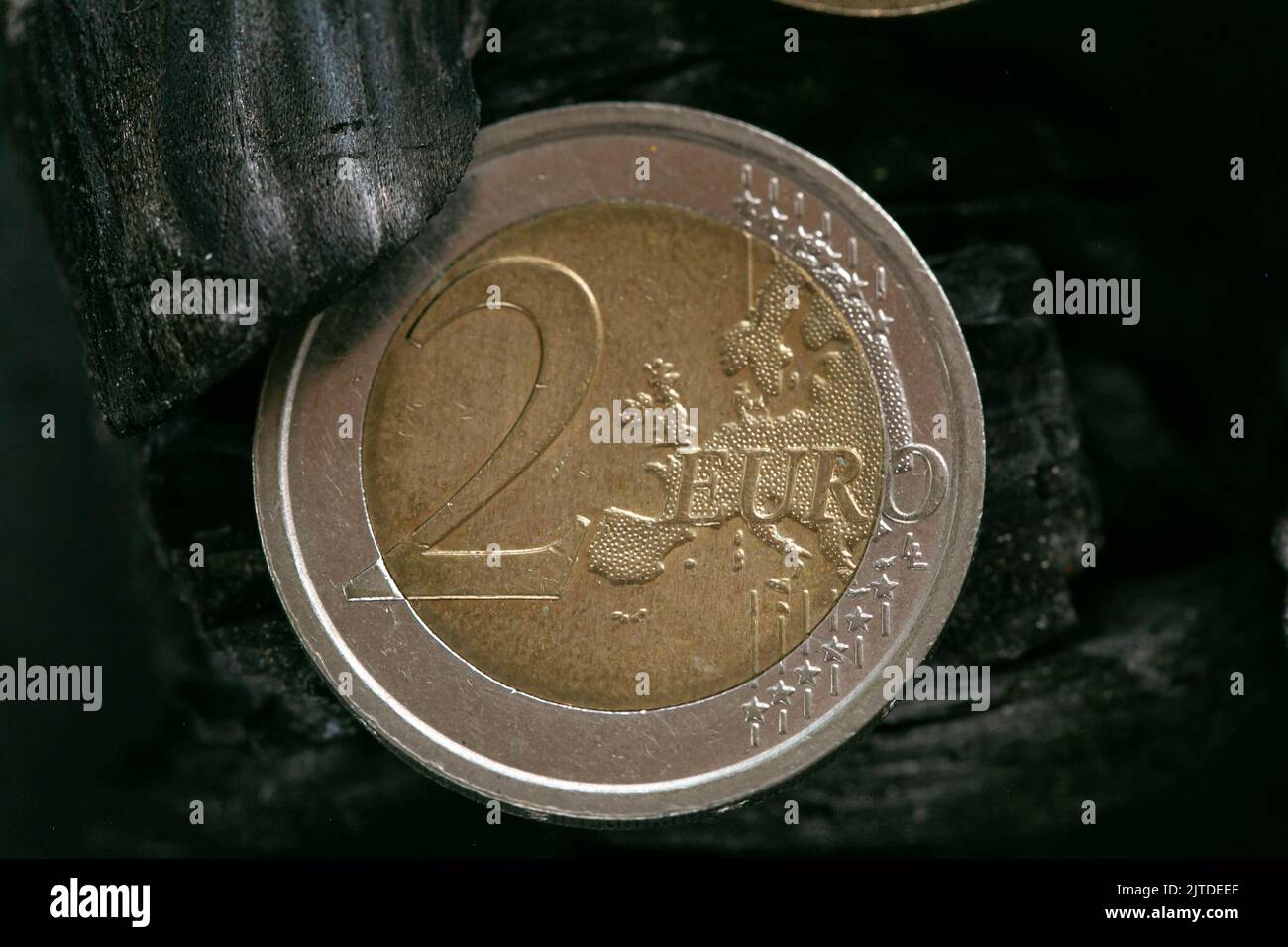 euro coin on a piece of coal. Charcoal and euro .Coal industry in the ...