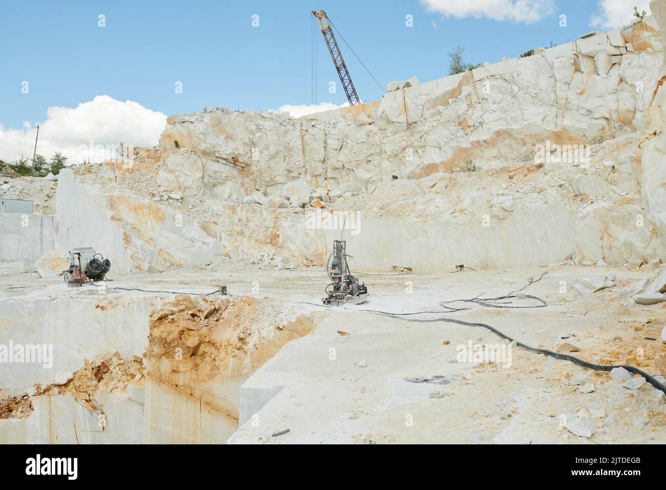 Part of large territory of modern marble quarry with thick white stone ...