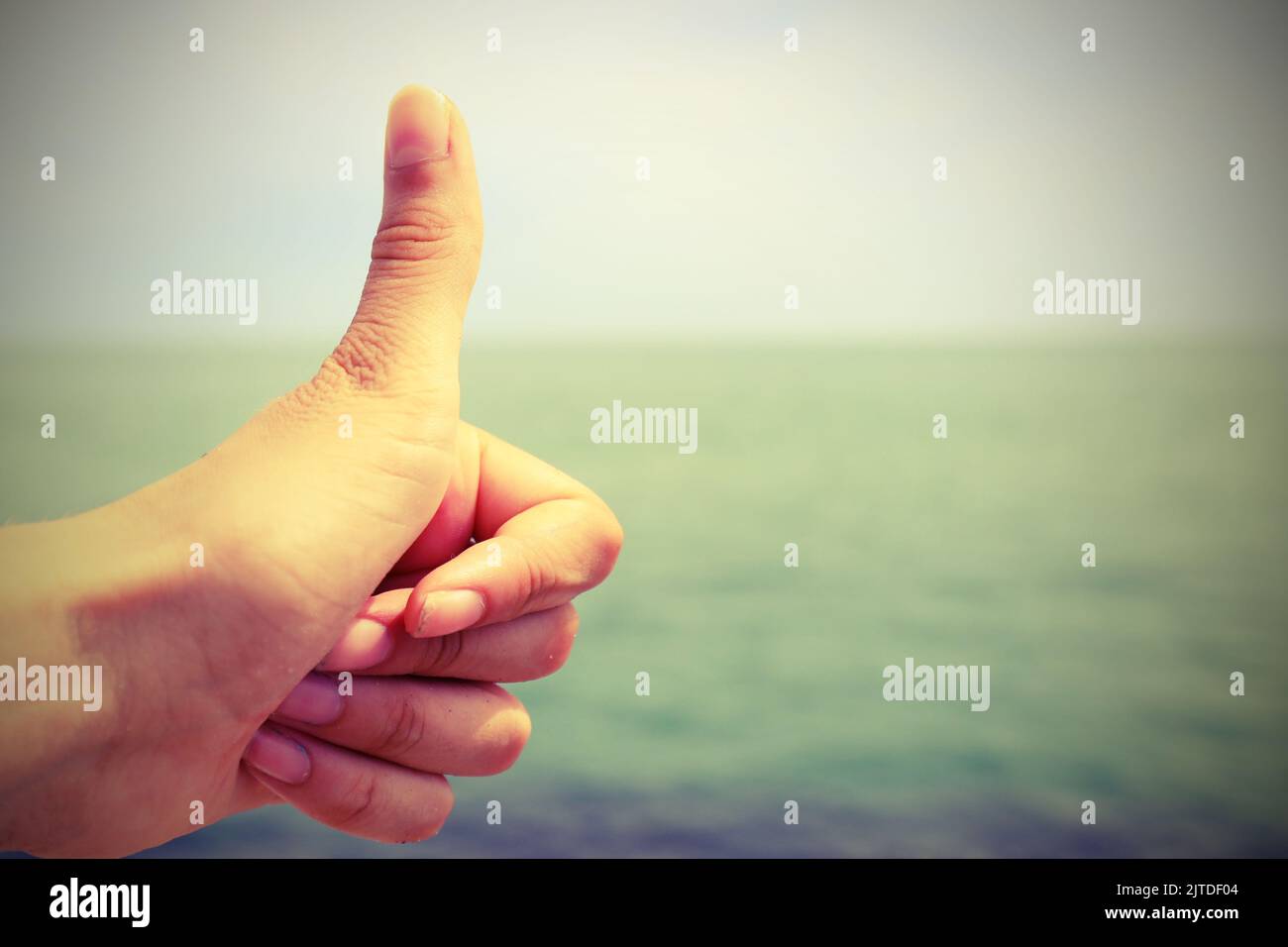 people hand with thumb raised as OK sign with antiqued effect Stock ...
