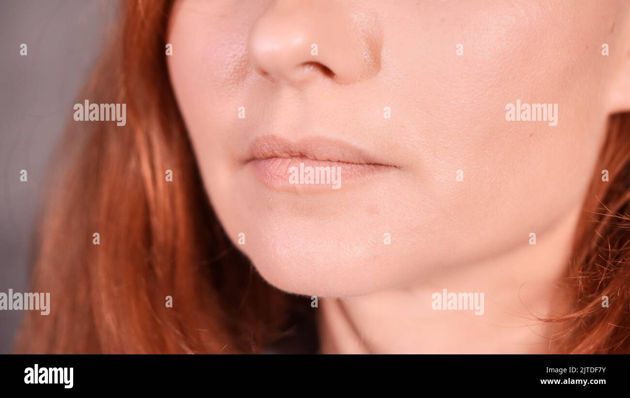 a close up of a frown of a Caucasian female with red hair Stock Photo ...