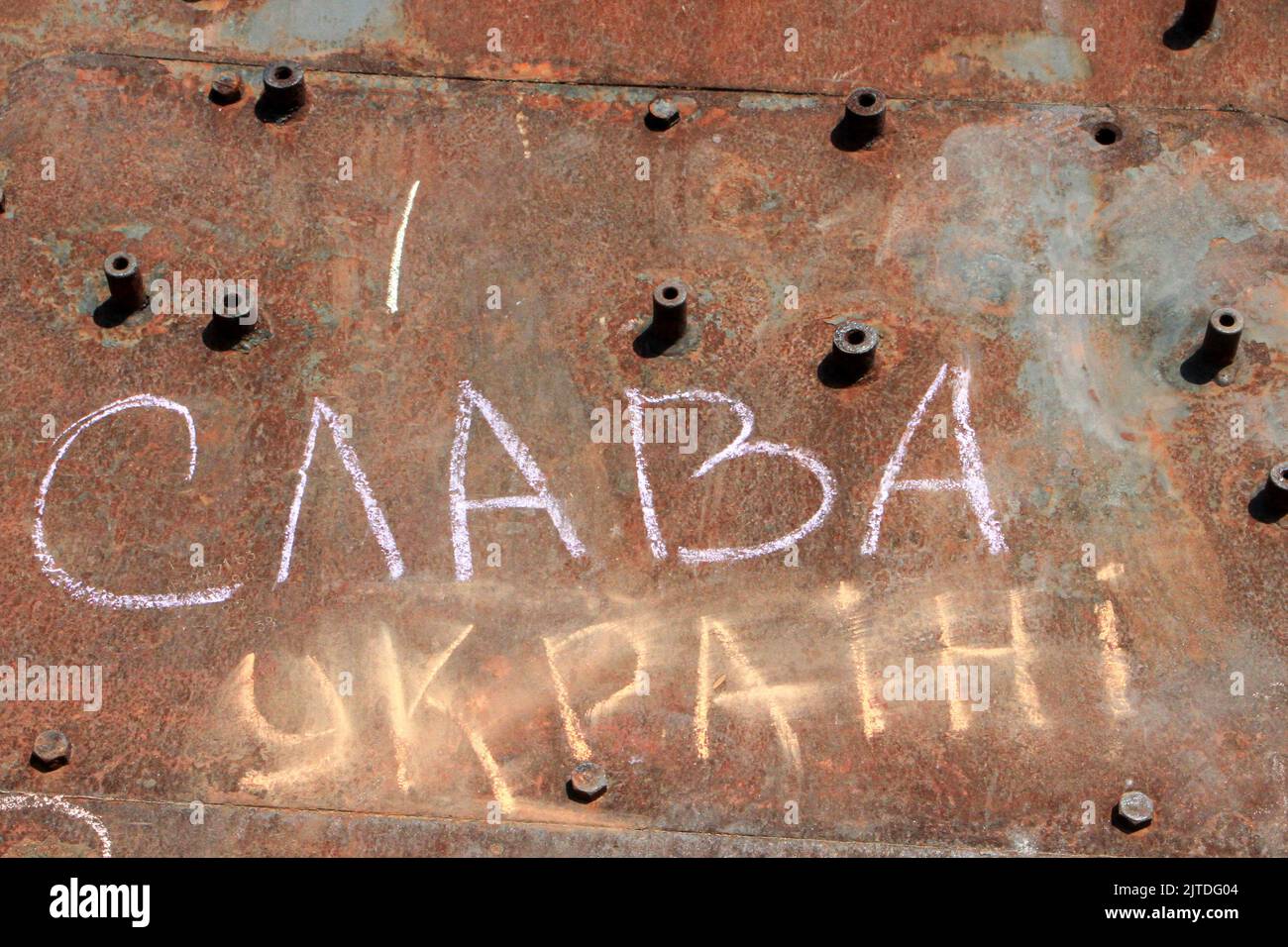 The inscription in Ukrainian "Glory to Ukraine" seen on the burnt armor ...