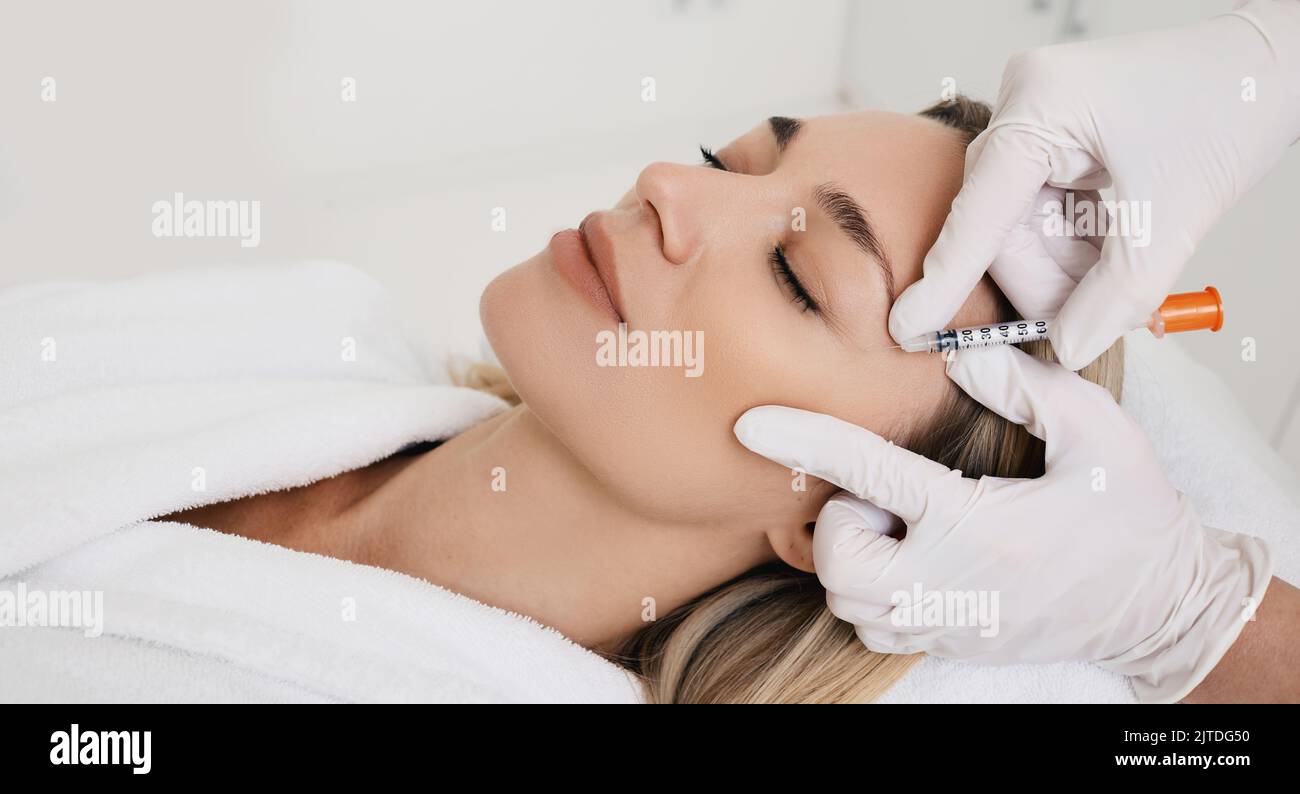 Beautiful woman during facial mesotherapy for smoothing of mimic ...