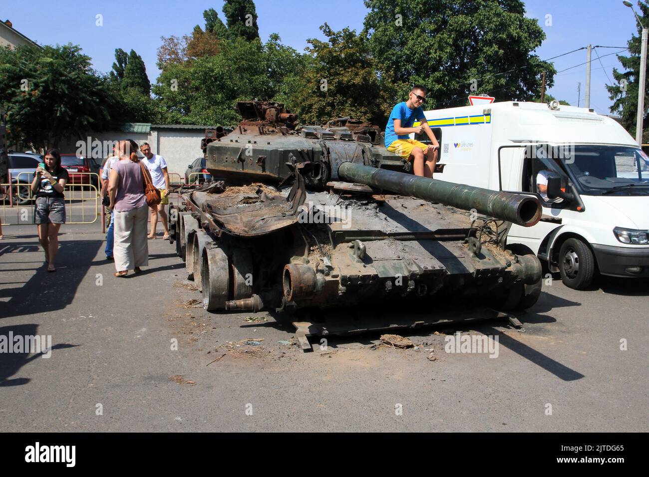 Odessa, Ukraine. 27th Aug, 2022. People walk near the burnt T-90 tank ...