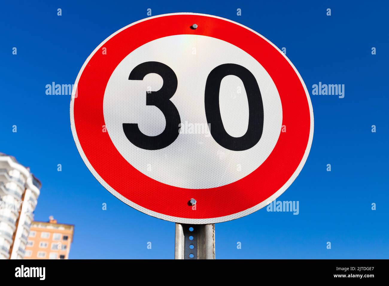 Round speed limit road sign is under blue sky Stock Photo - Alamy