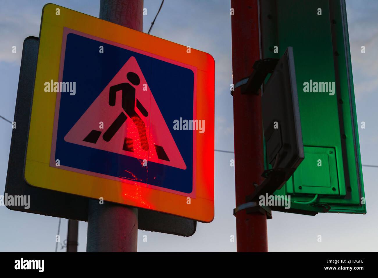 Pedestrian crossing. Road sign with colorful illumination of traffic ...