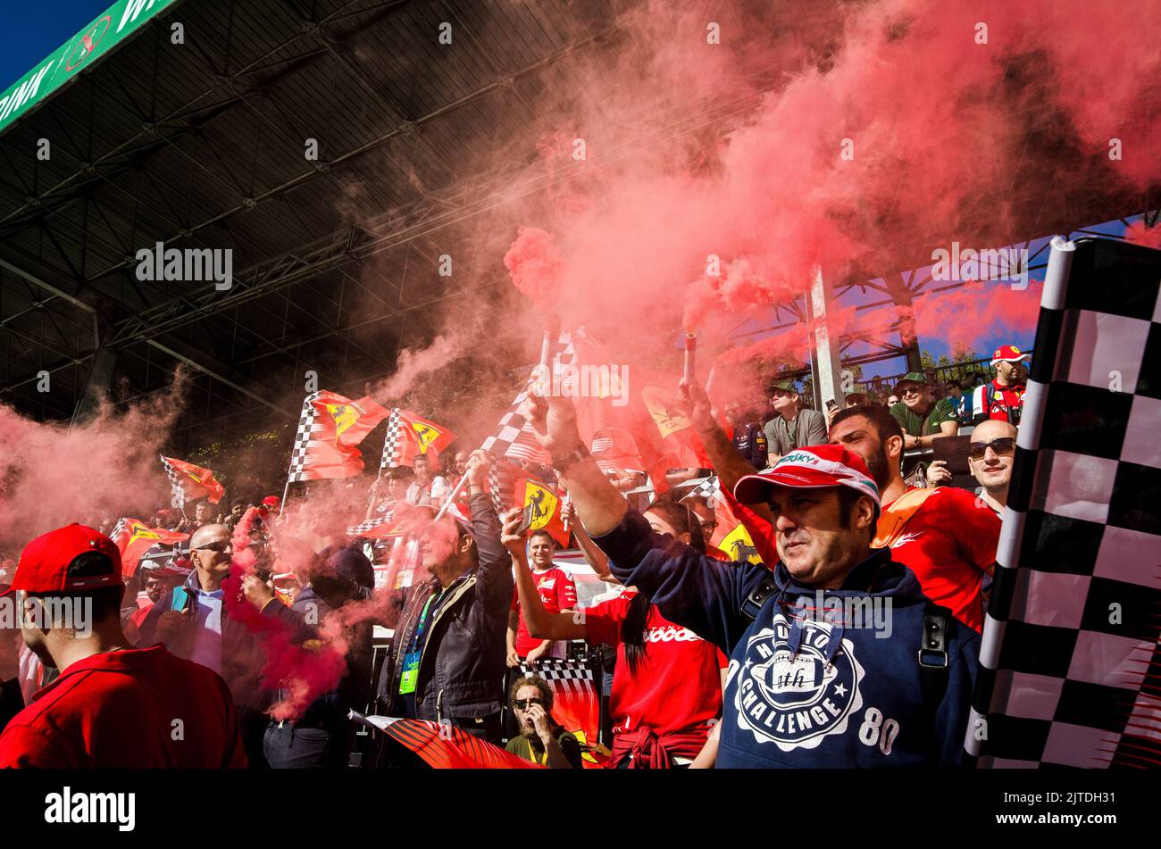 Scuderia Ferrari fans hold smoke flares in the stands as they wait for ...