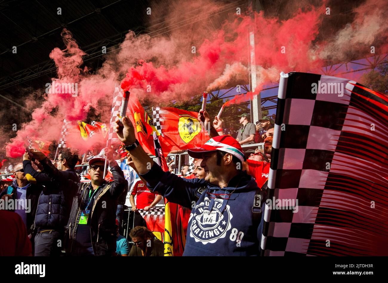 Scuderia Ferrari fans hold smoke flares in the stands as they wait for ...