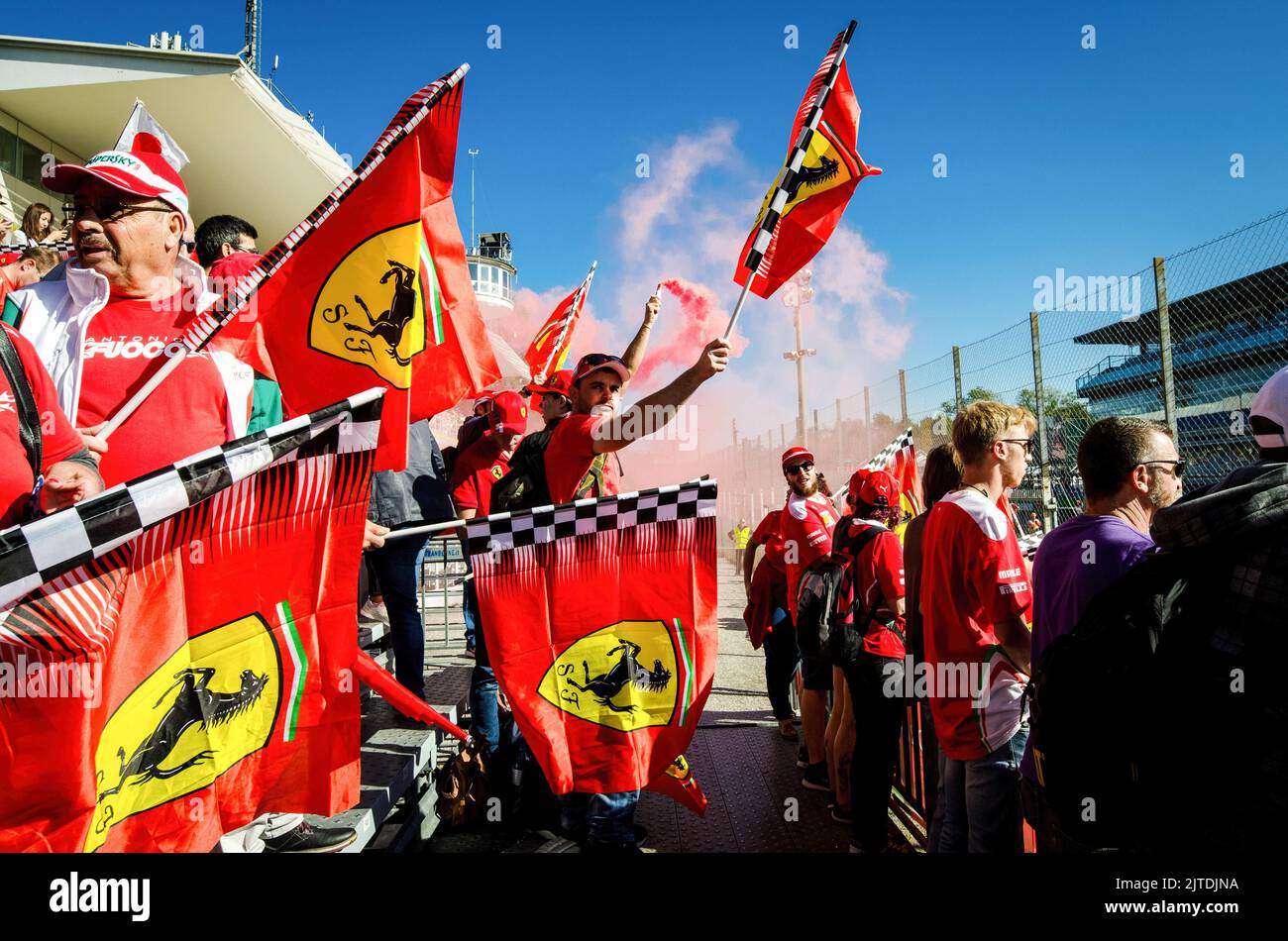 Scuderia Ferrari fans hold smoke flares in the stands as they wait for ...