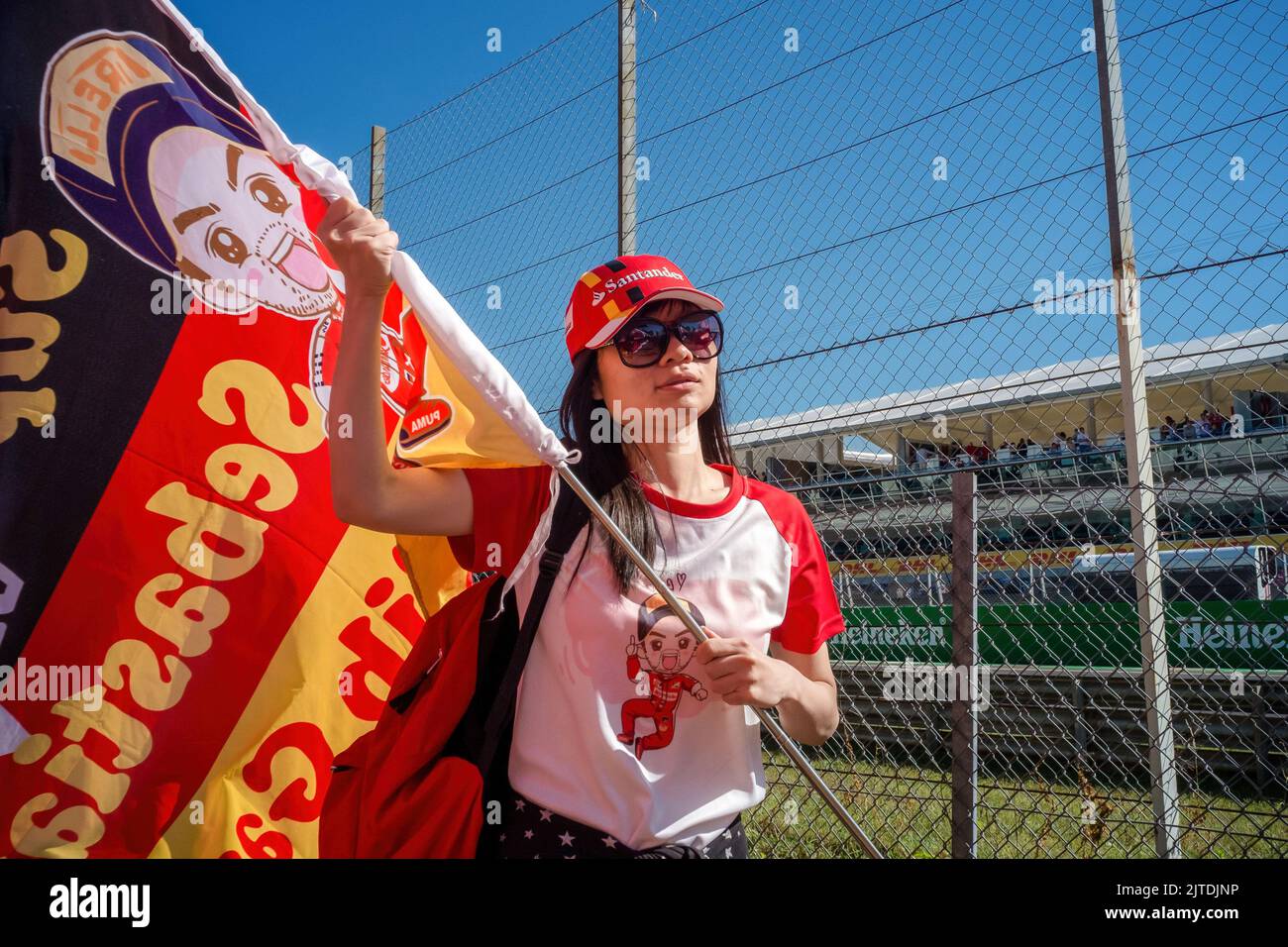 Monza, Italy. 03rd Sep, 2017. An Asian Scuderia Ferrari fan waves a ...