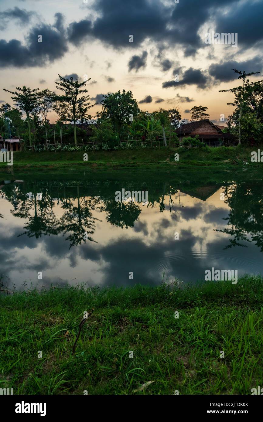 Colorful sunset, sunrise over a wide river. Twilight rays and clouds ...