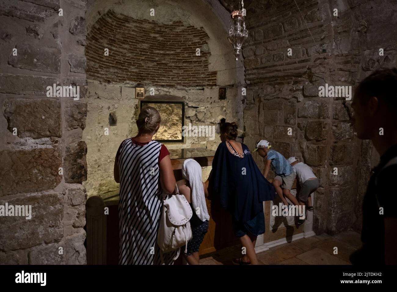 Tourists visit the Greek Orthodox Chapel of Adam in the Church of Holy ...