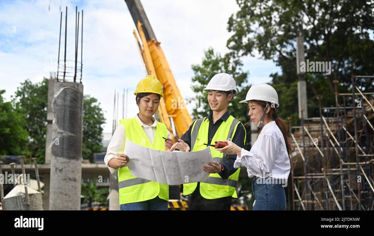 Architect and civil engineer in safety helmet discussing, planning ...