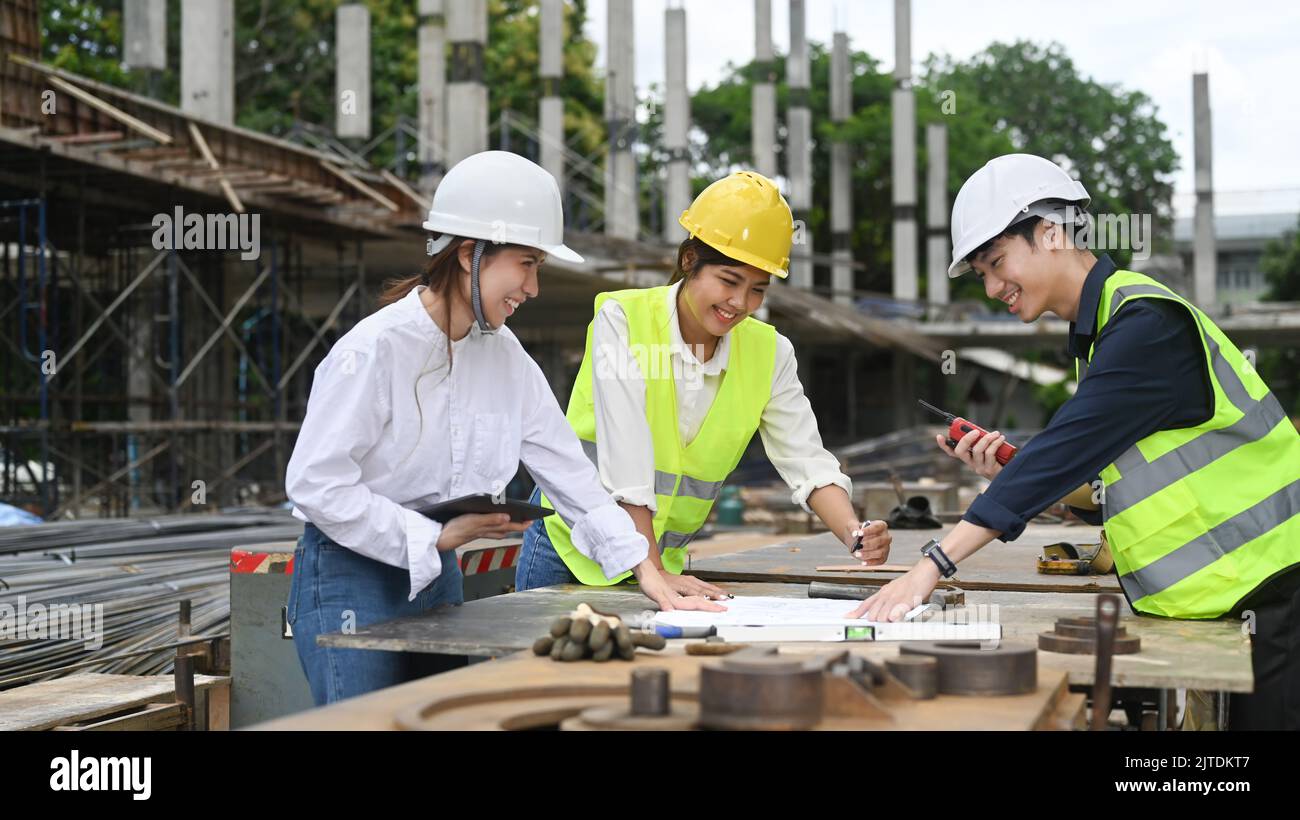 Team of civil engineers and architect discussing project details and ...