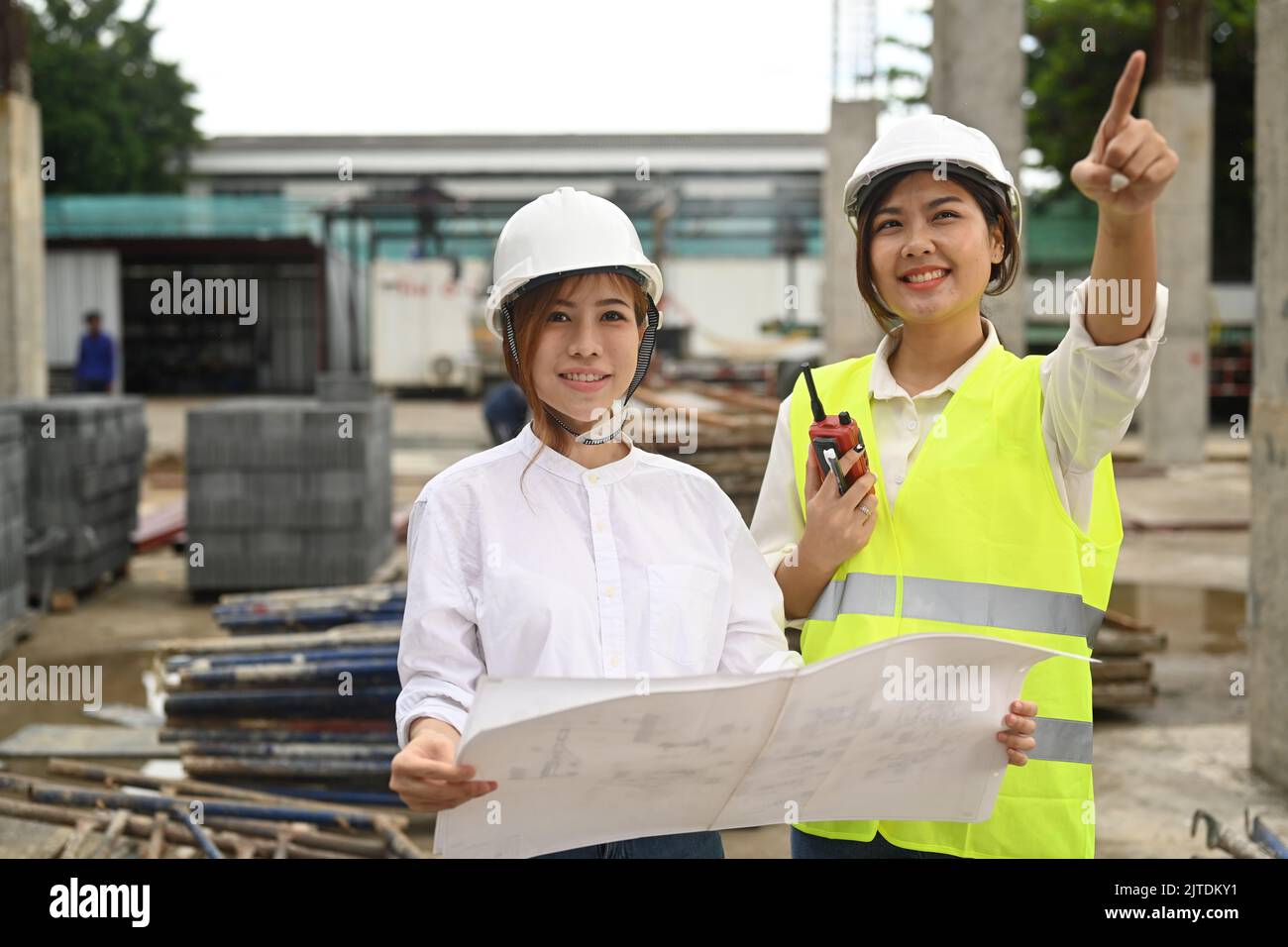 Female architects and inspectors supervising progress of construction ...