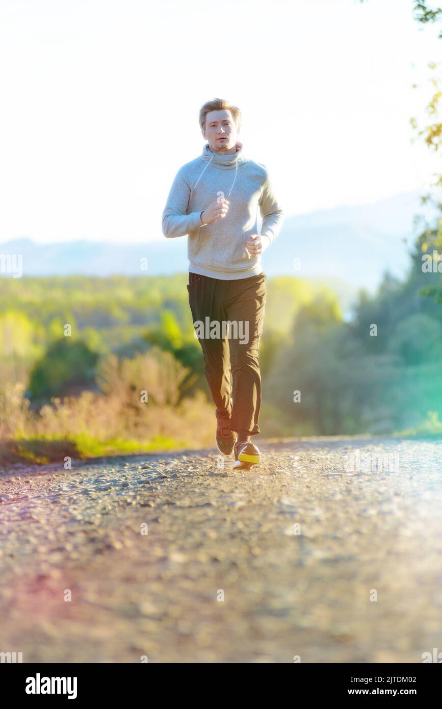 Running man jogging in rural nature at beautiful summer day. Sport ...