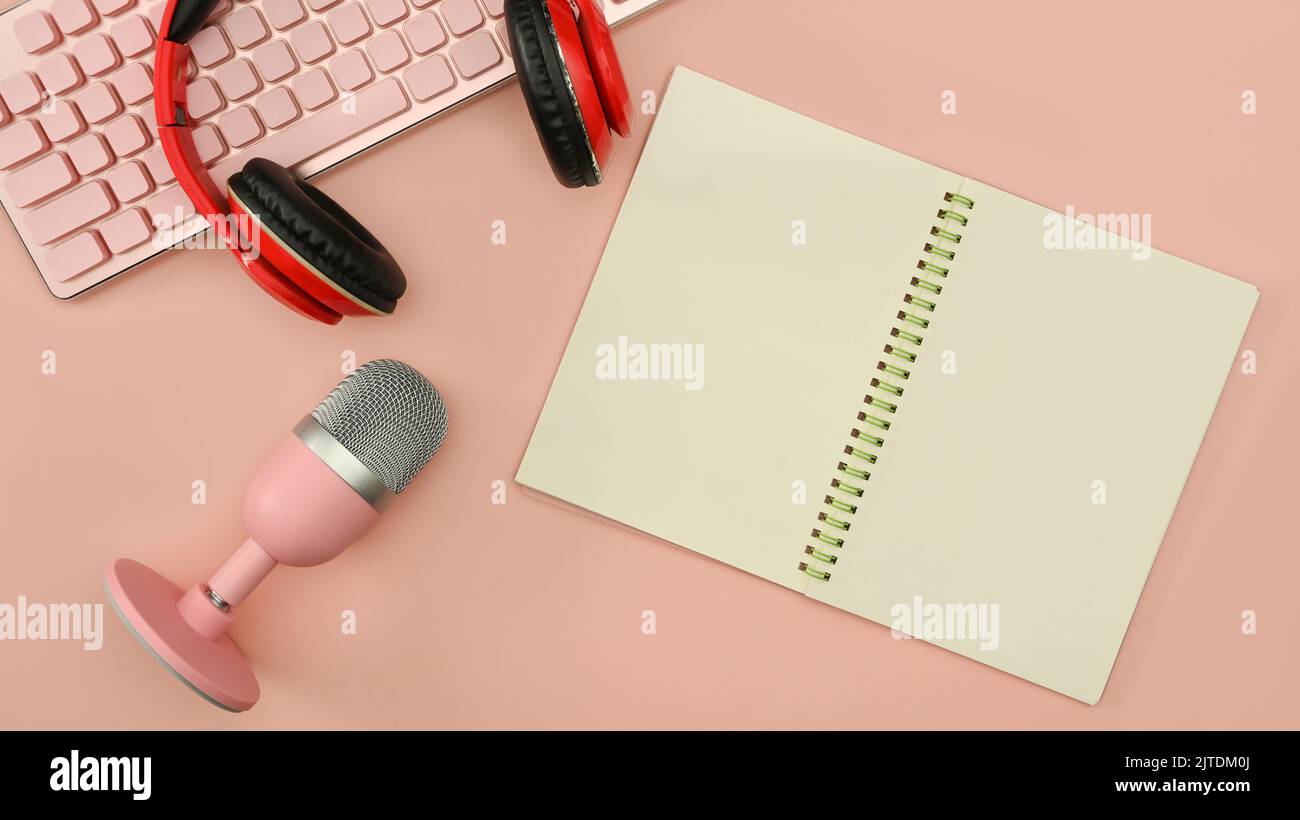 Top view microphone for podcasts, notepad and wireless headphones on ...