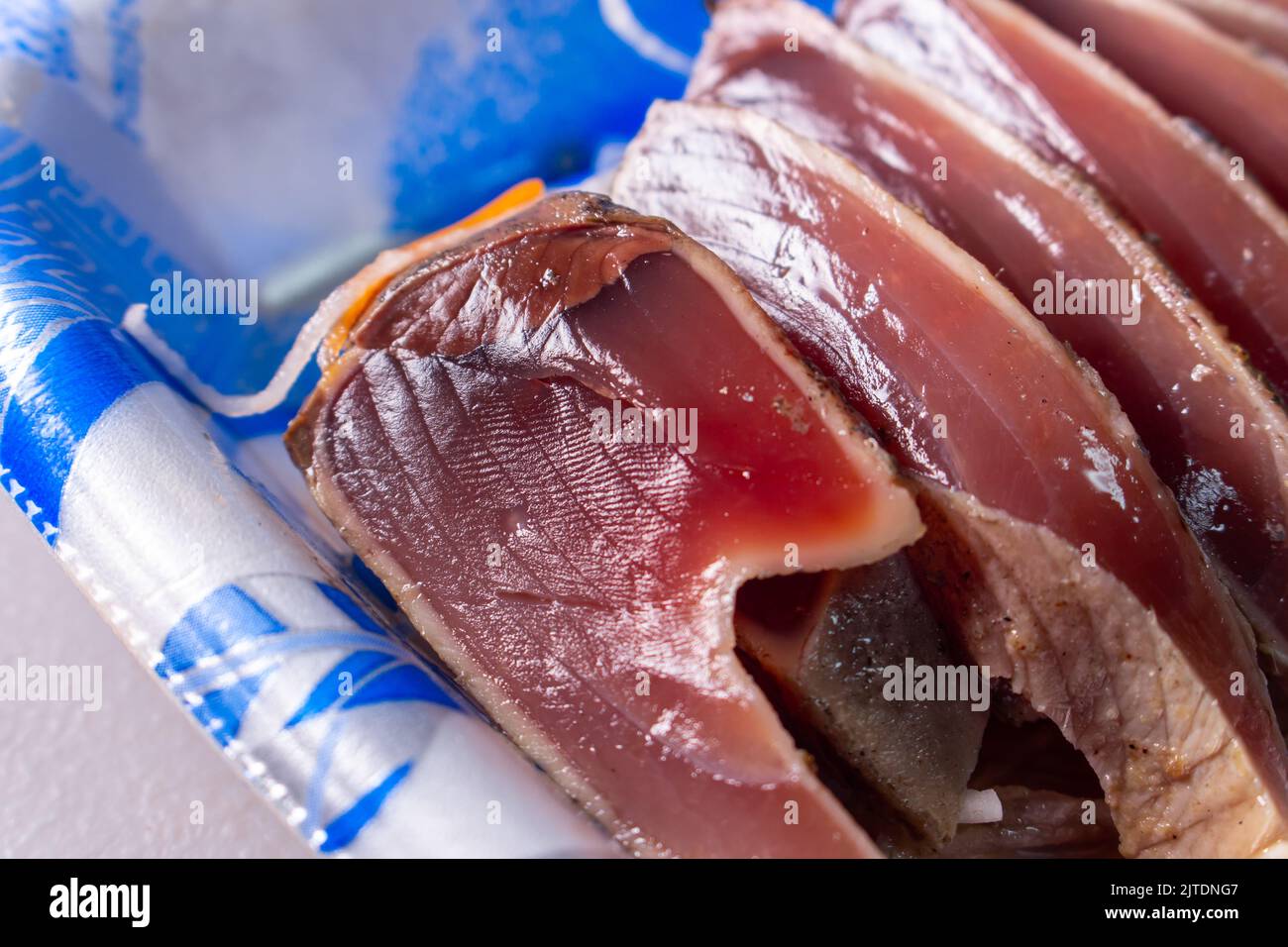 Closeup takeout Katsuo-no-Tataki (lightly broiled, sliced bonito ...