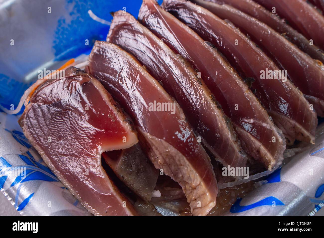 Closeup takeout Katsuo-no-Tataki (lightly broiled, sliced bonito ...