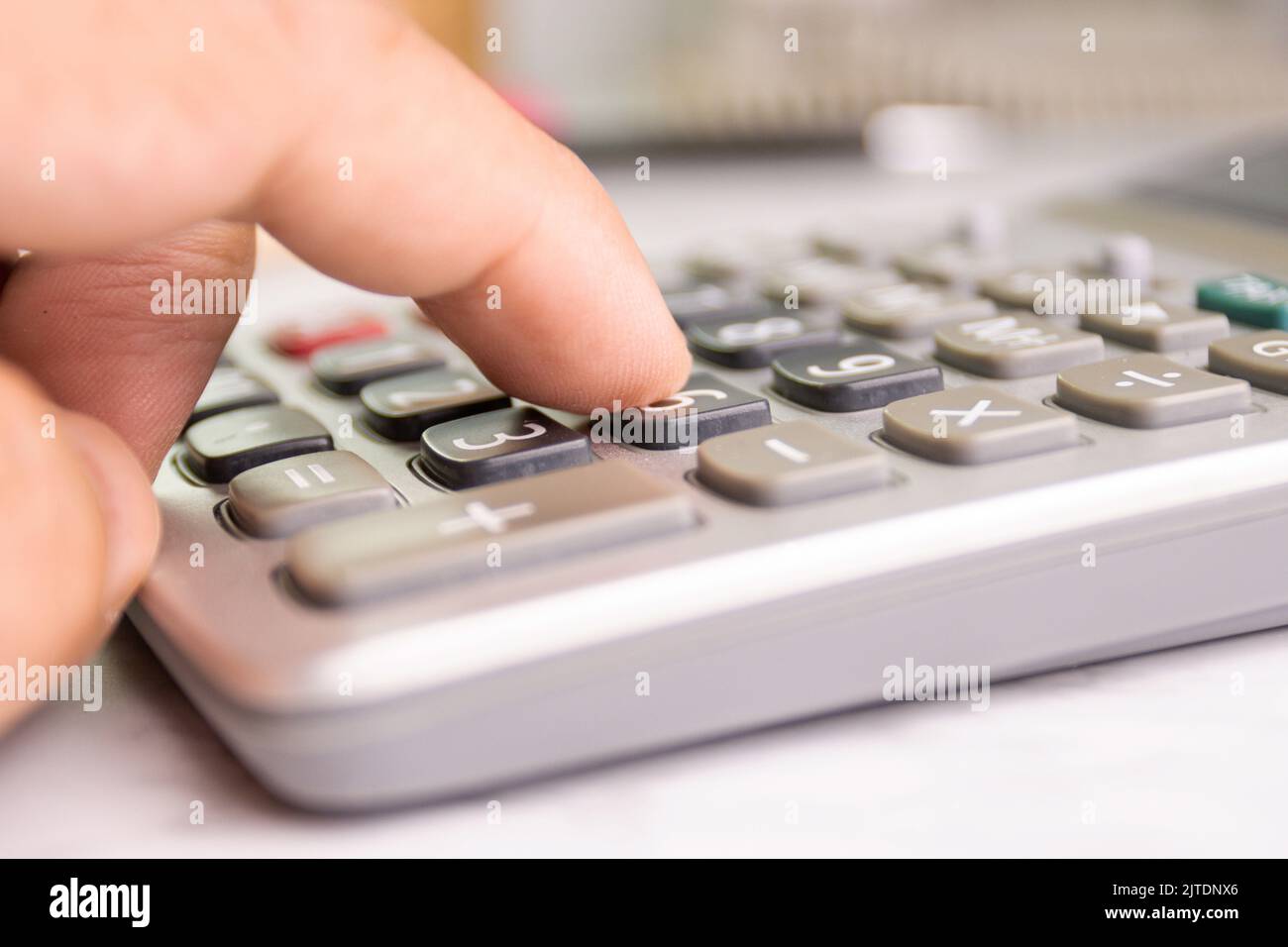 close up human finger push number button of calculator concept ...