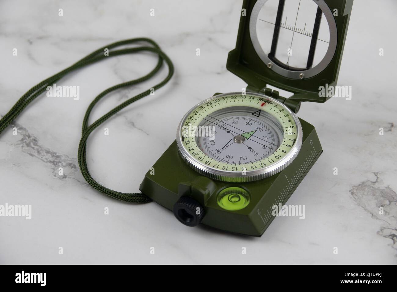 A navigation compass on a marbled surface, closeup shot Stock Photo - Alamy