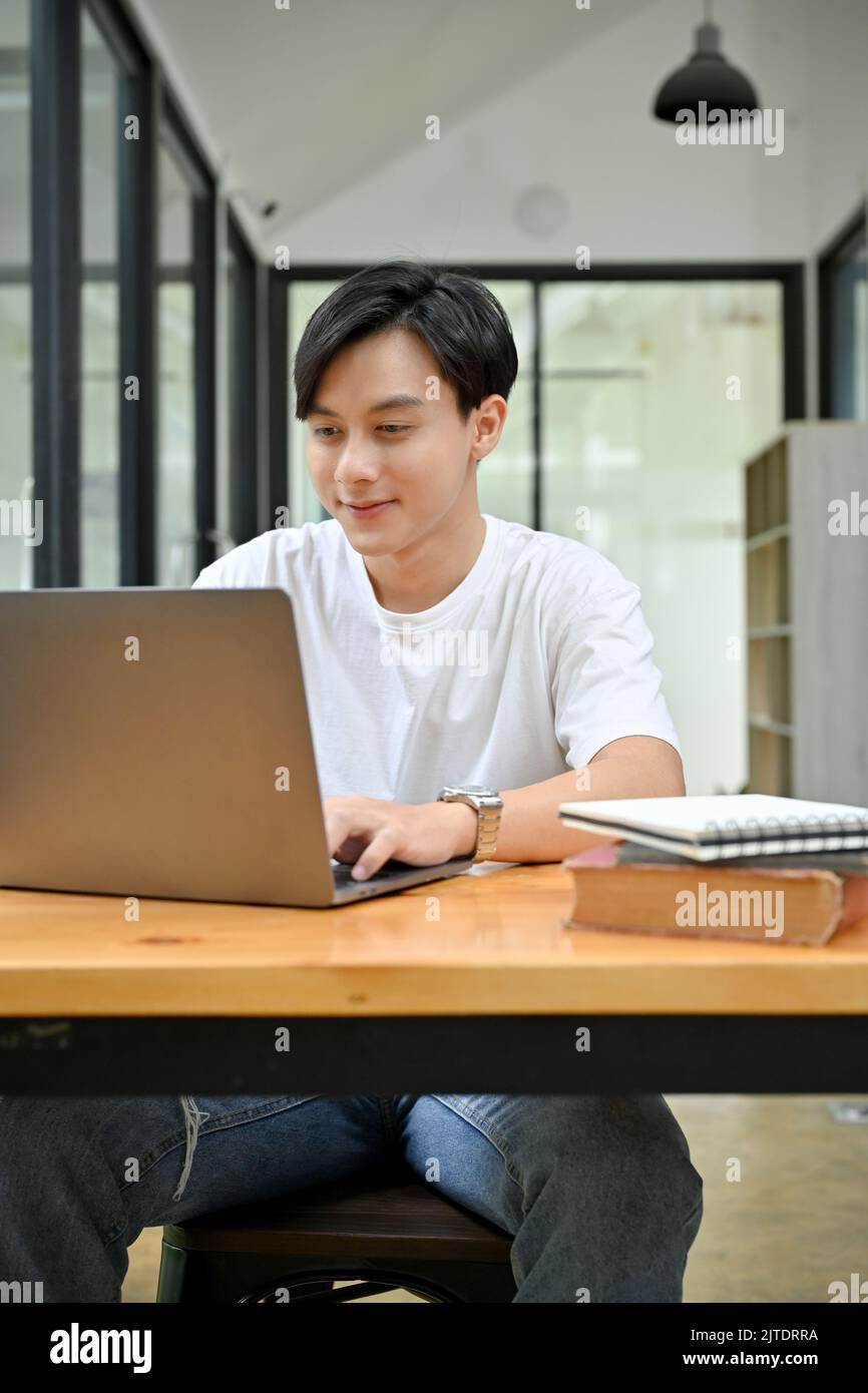 Portrait, Handsome and smart young Asian male college student doing his ...