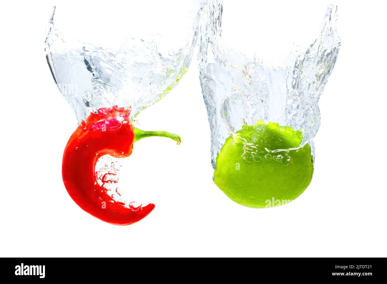 Curled red pepperoni and fresh whole lime dropped in water with ...