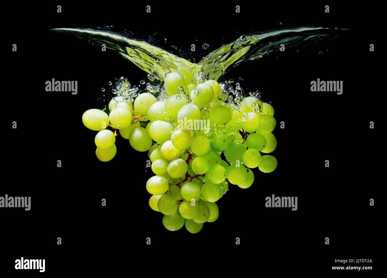 White grapes splashing underwater isolated on black background Stock ...