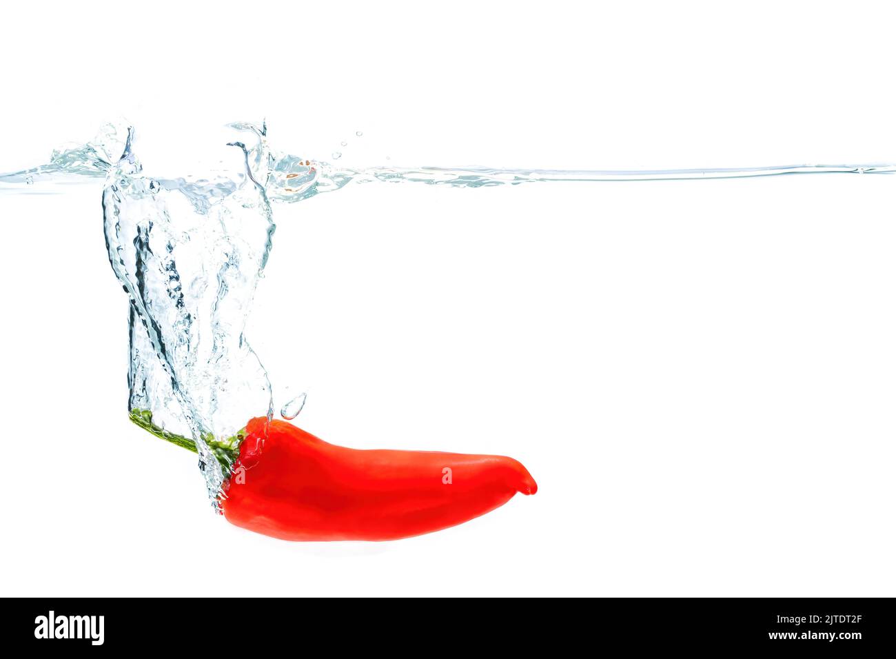 Red chilli dropped in water with splashes isolated on white background ...
