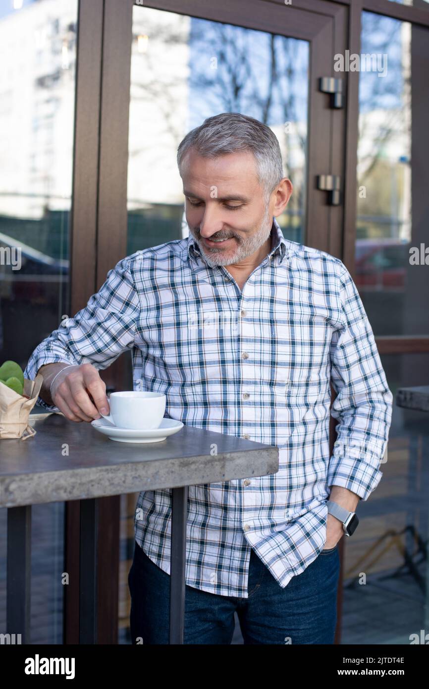 Street cafe visitor enjoying his coffee break Stock Photo - Alamy