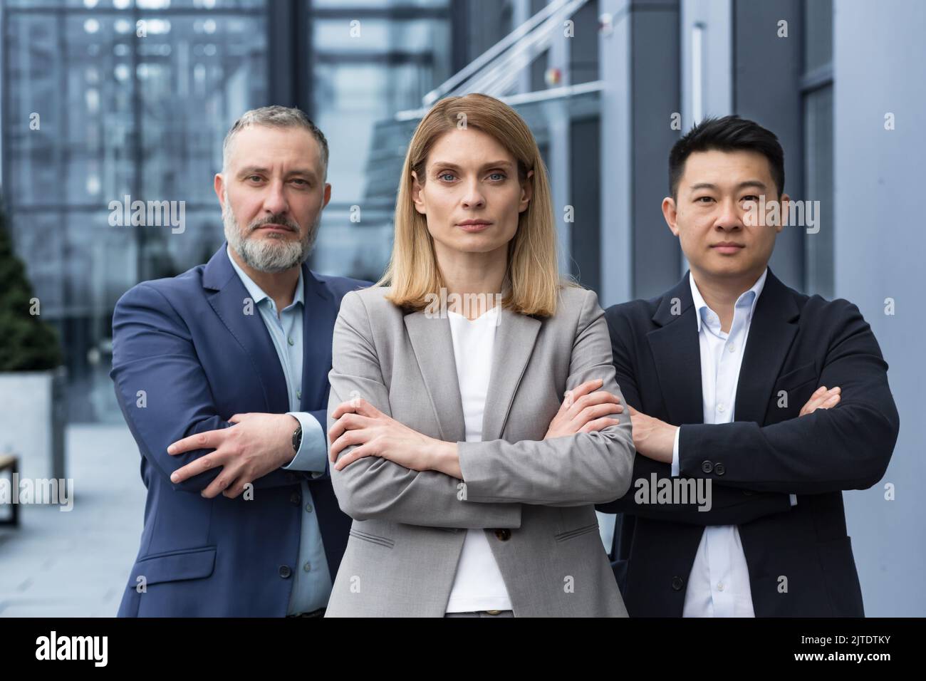 Successful and serious diverse team of three business people, man and ...