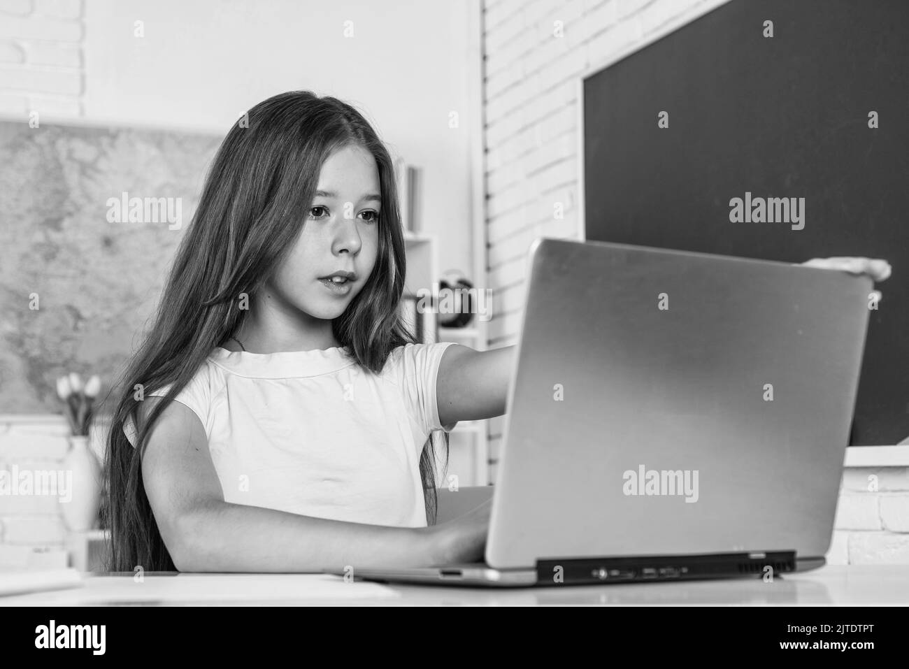 cheerful kid girl with computer at school lesson, e learning Stock ...