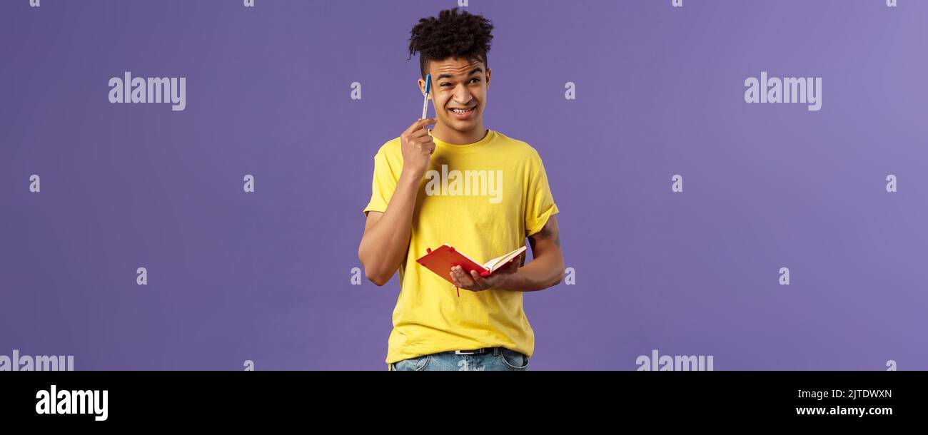 Young troubled male student studying, doing homework, scratch head ...