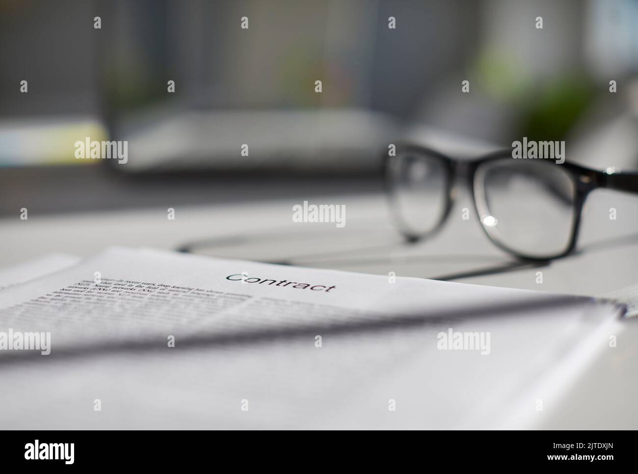 Insurance agreement or job contract on an office desk, with glasses in ...
