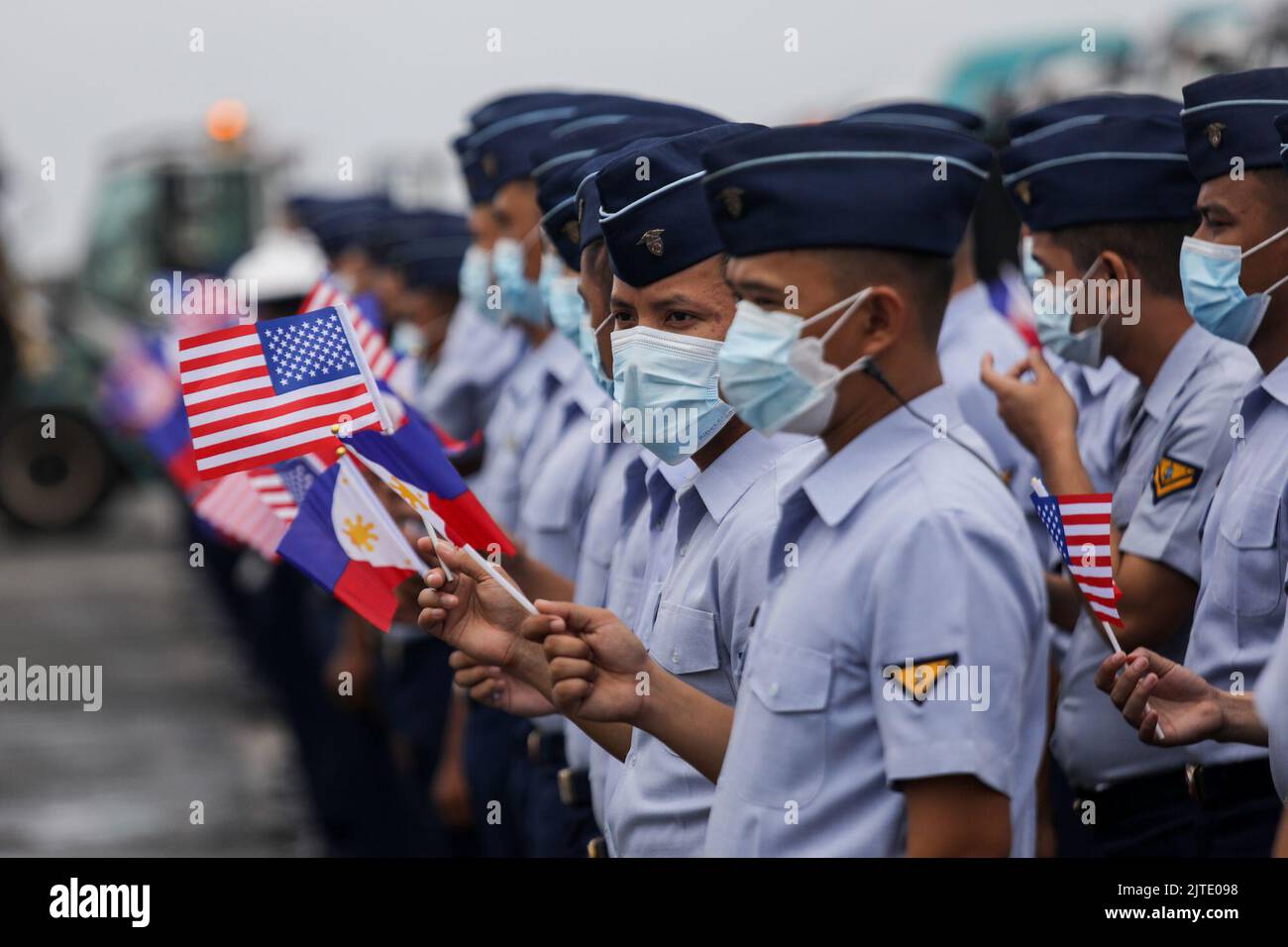 Manila, Philippines. 30th Aug, 2022. Members of the Philippine Coast Guard wave Philippine and ...