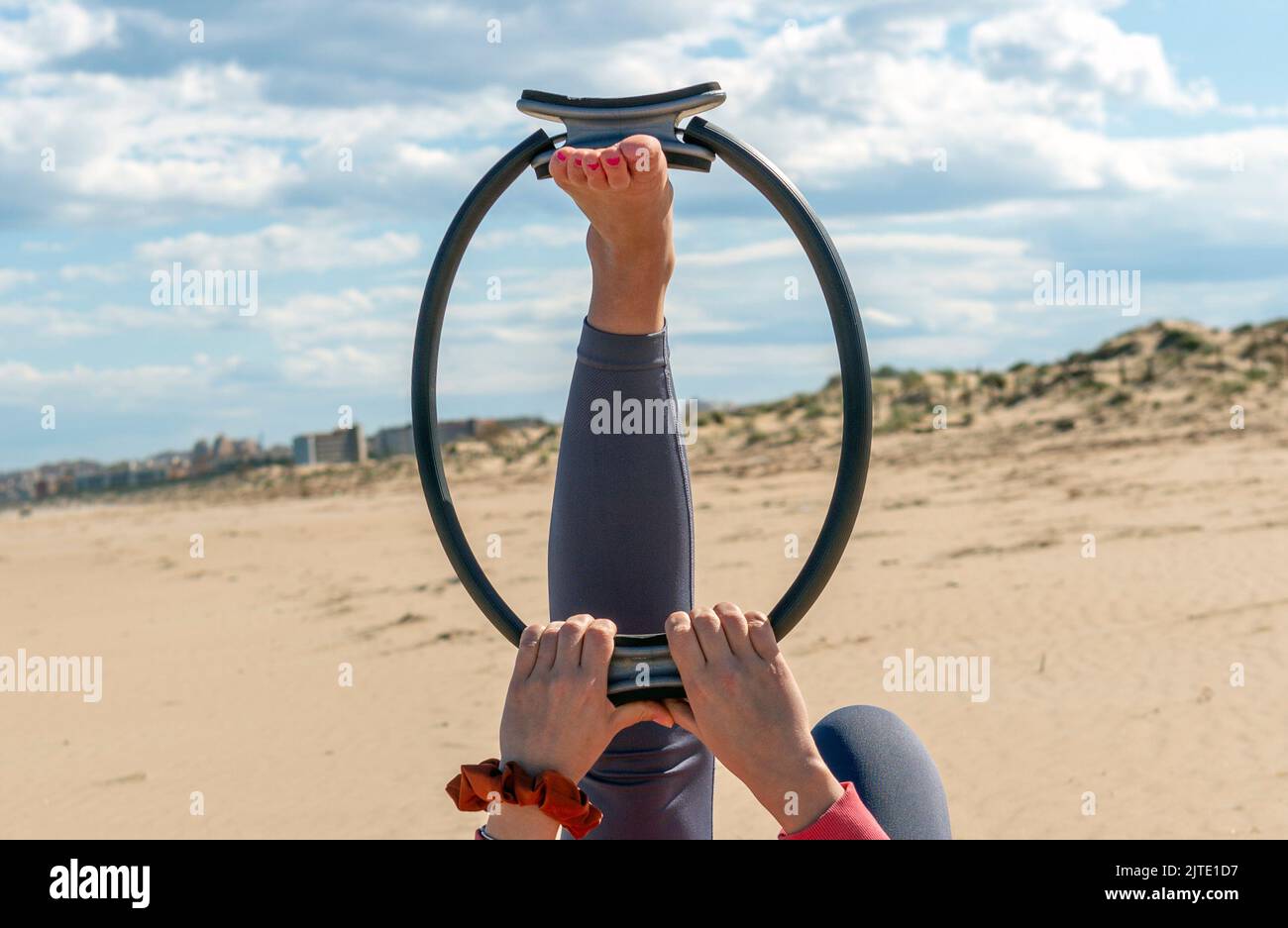 photo of pilates ring with female hands and foot Stock Photo - Alamy