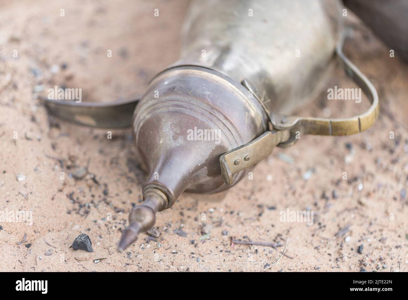 A Dallah traditional coffee pot on sand desert Stock Photo - Alamy