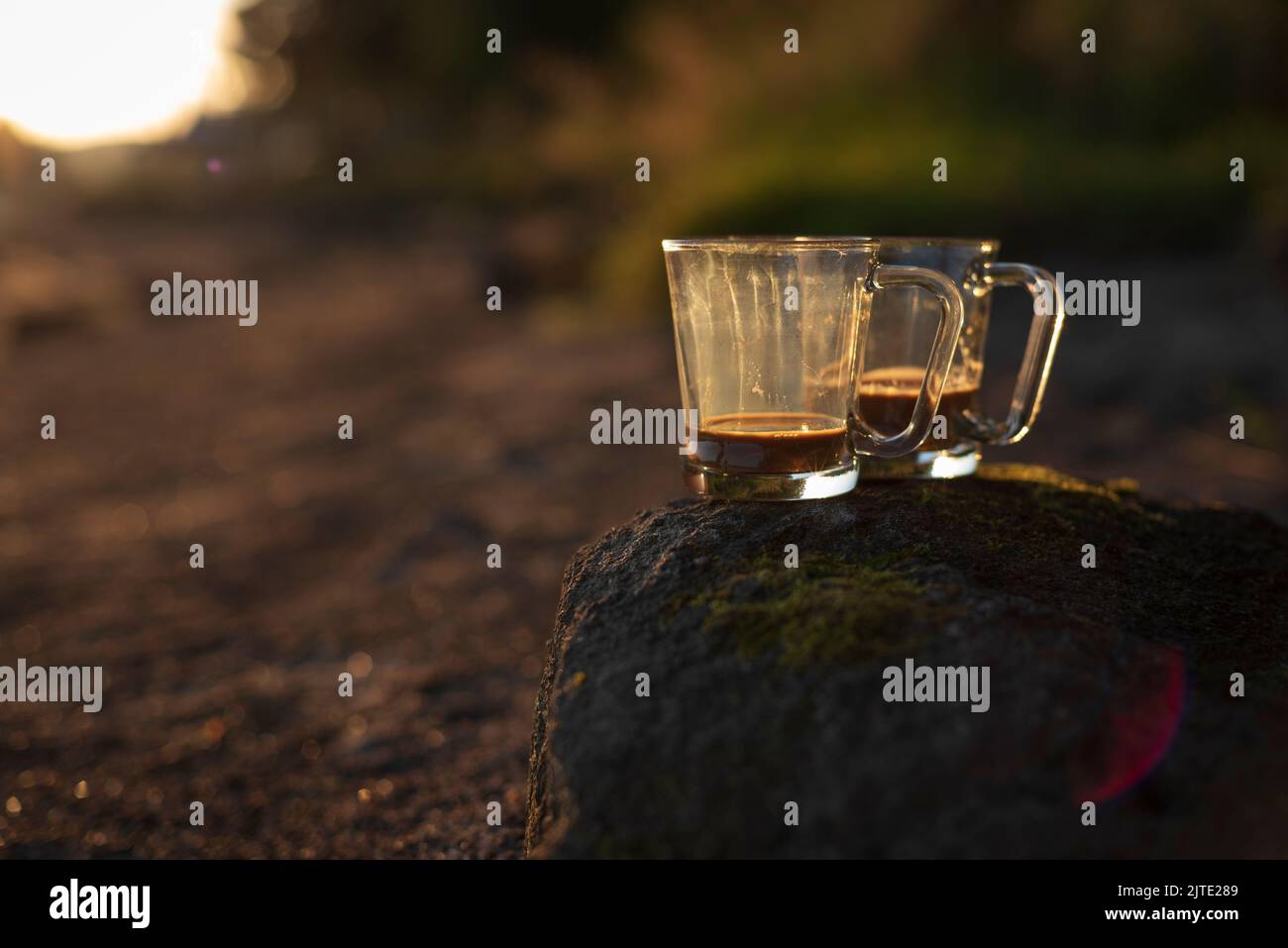 The two coffee cups on the rock at a sunset Stock Photo - Alamy
