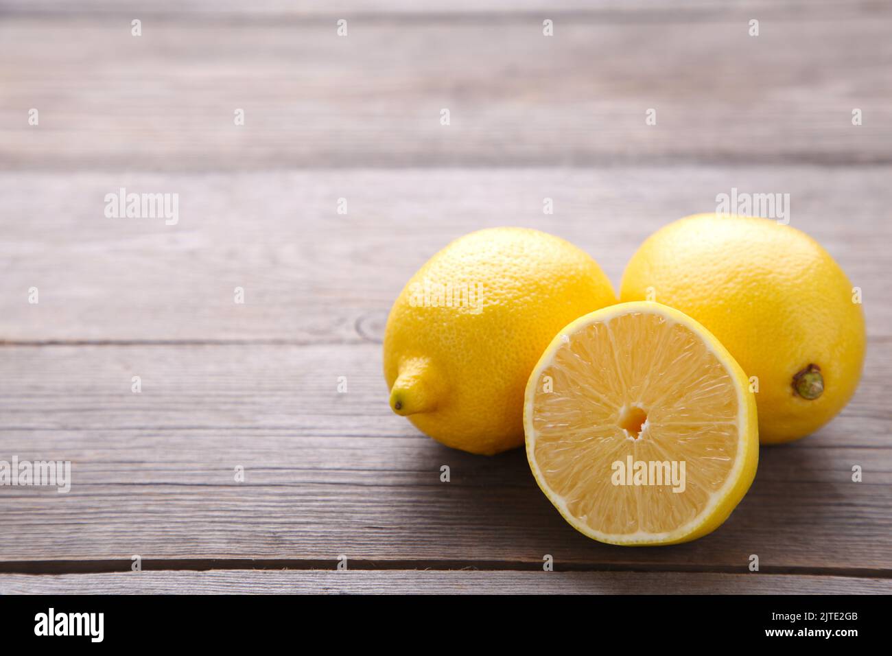 Lemon and half of lemon on grey background. Fresh tropical fruit Stock ...