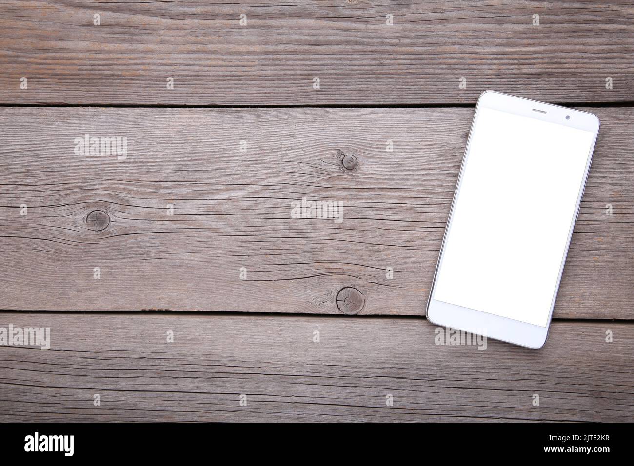 Mobile phone with blank screen on grey wooden table. Smartfone white ...