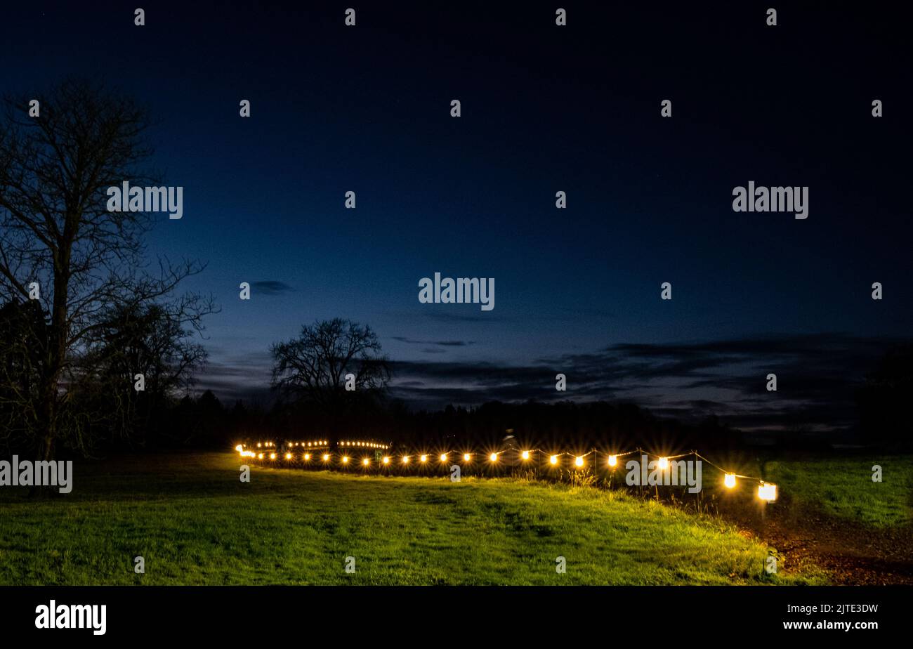 Illuminated lantern walk across the fields at an English country house ...