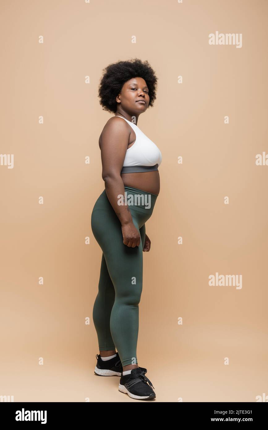 full length of curly african american plus size woman in crop top and ...