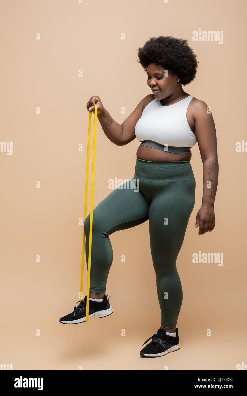 full length of happy african american plus size woman in sportwear ...