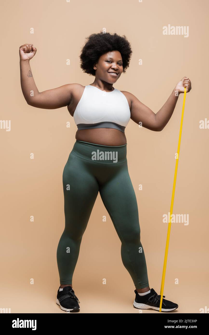 full length of joyful african american plus size woman in sportwear ...