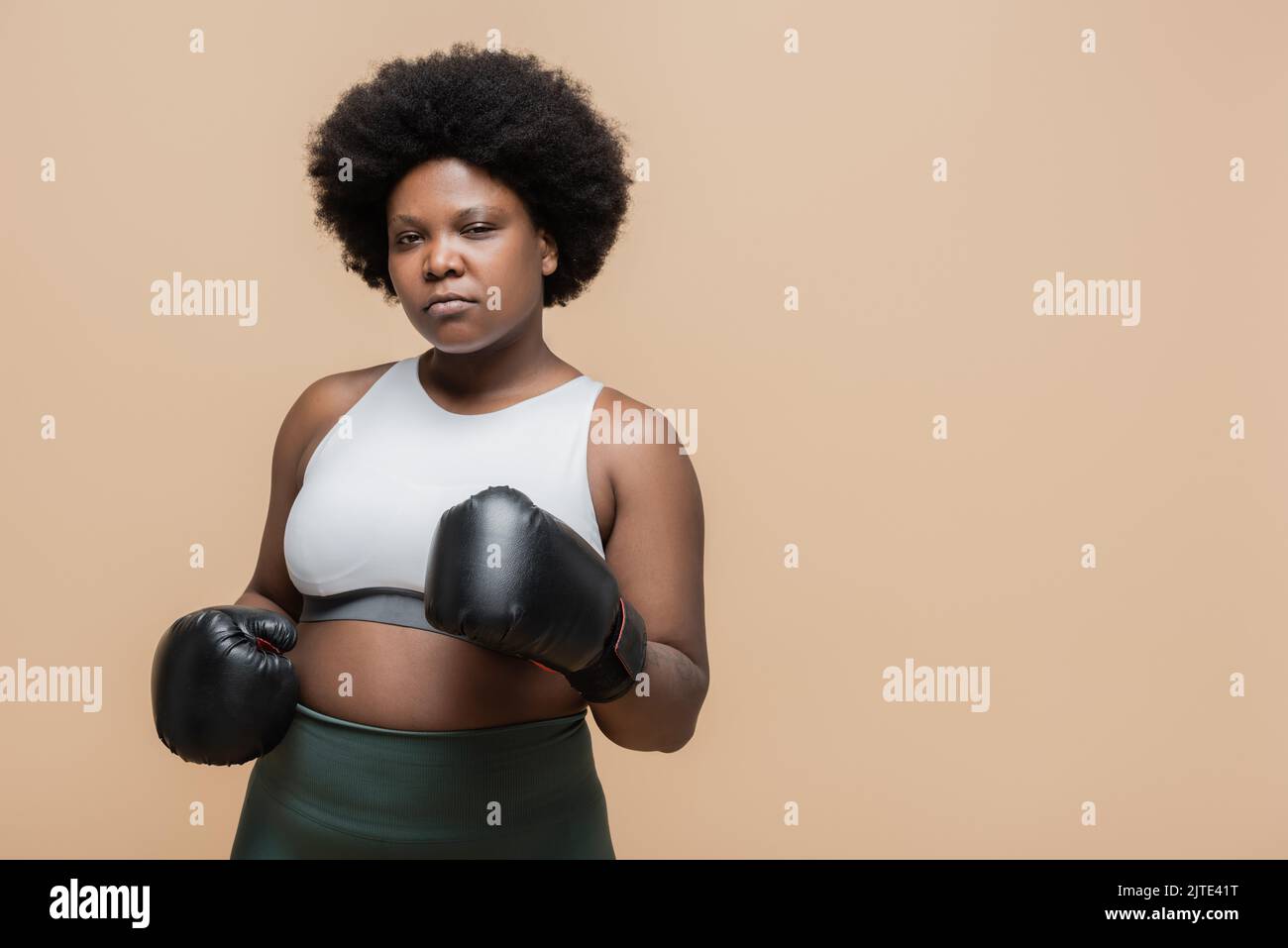 serious african american plus size woman with boxing gloves isolated on ...