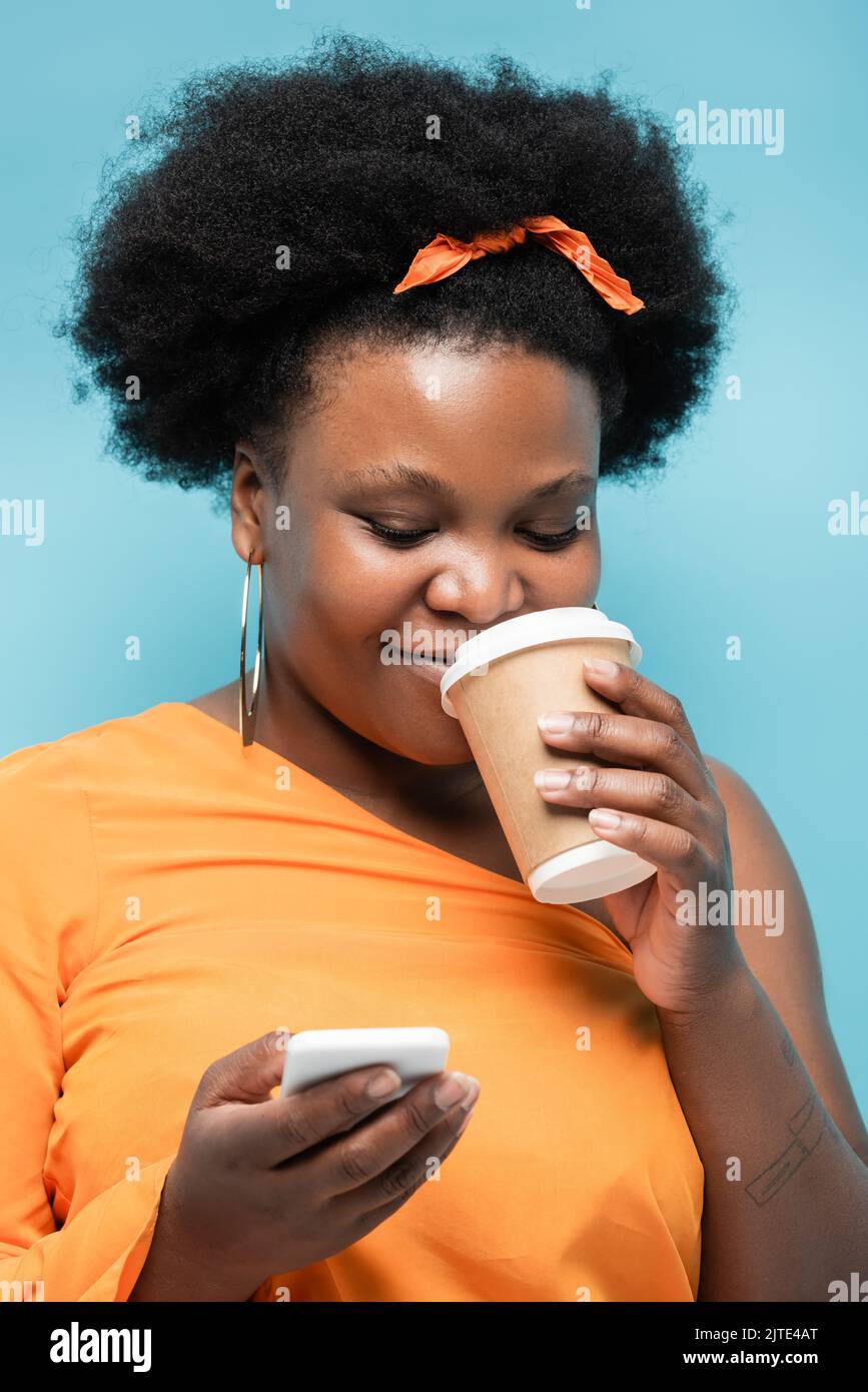 Pleased African American Body Positive Woman In Hoop Earrings Holding
